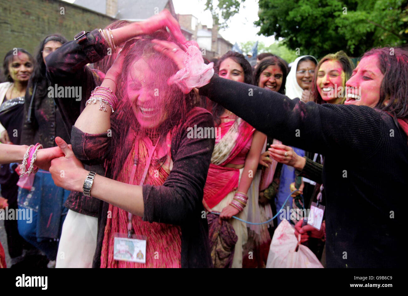 Young Hindu women throw powder paint at each other, a tradition in ...