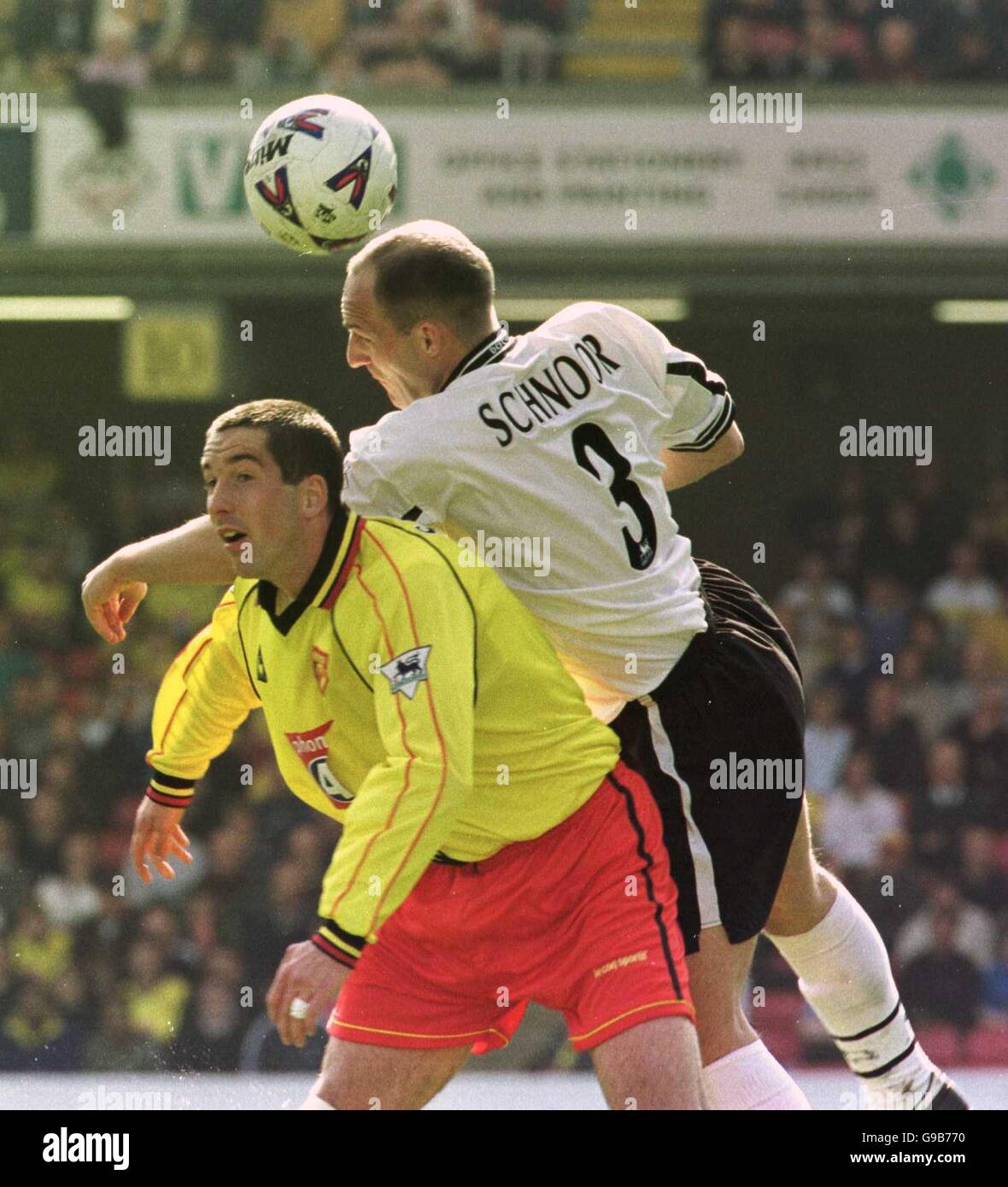 Derby County's Stefan Schnoor climbs all over Watford's Allan Smart to ...