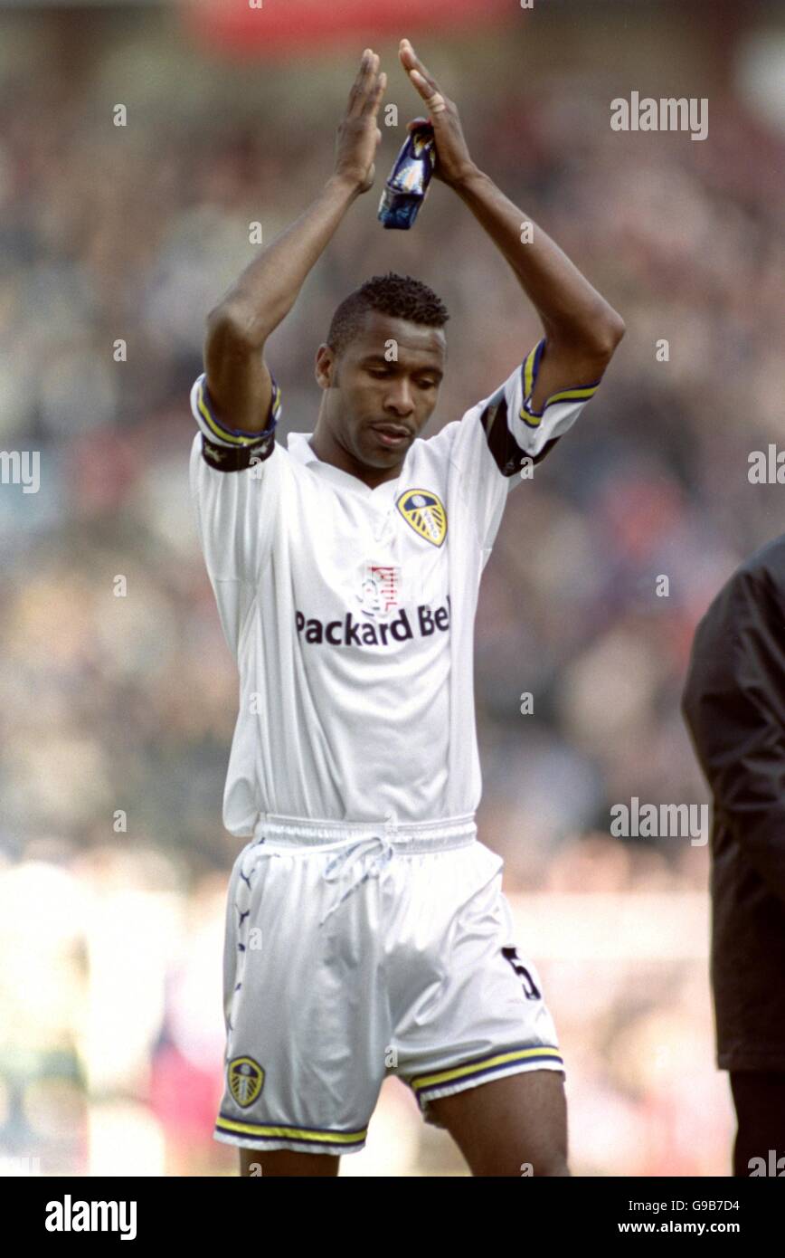 Leeds United's captain Lucas Radebe applauds the travelling supporters ...