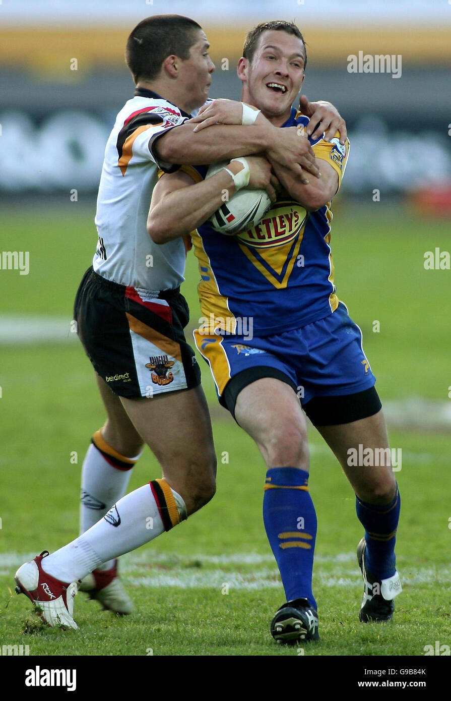 Bradford's Paul Deacon (left) tackles Leeds' Danny McGuire during the ...