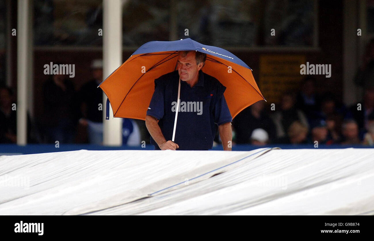 Head groundsman Steve Rouse checks the rain sodden covers ahead the ...
