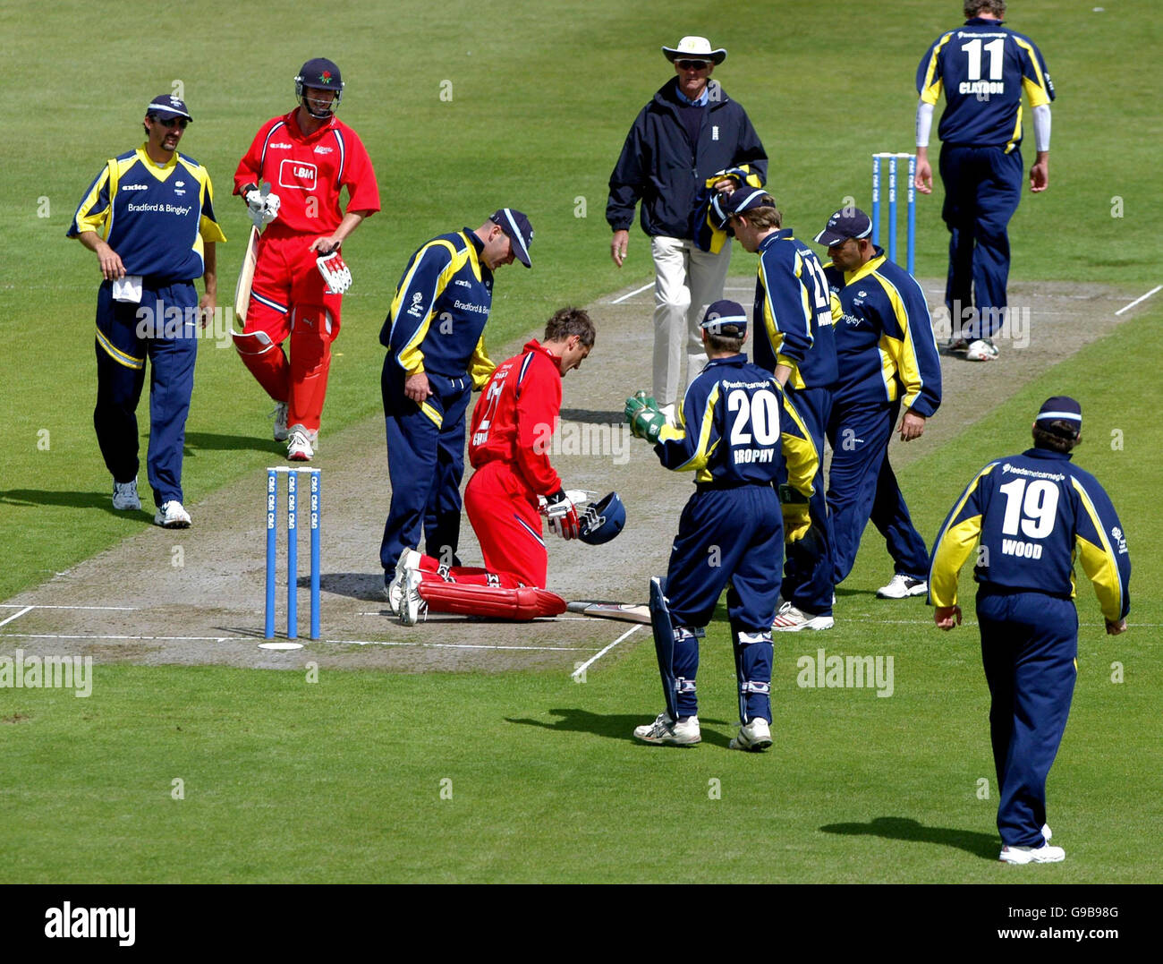 Lancashire's Mark Chilton (C) receives attention from Yorkshire players ...