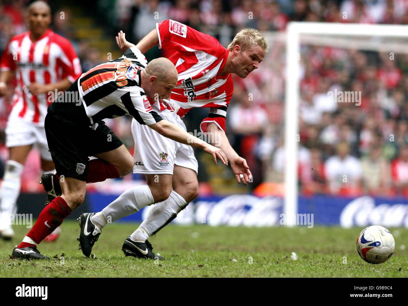 Grimsby Town's Andy Parkinson (L) tussles with John Finnigan of ...