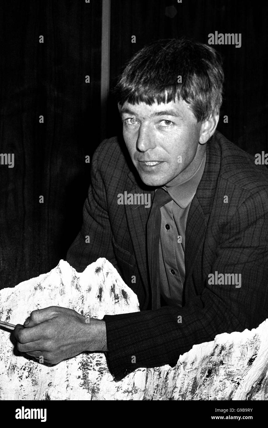 Behind a model of mountain ranges of the Andes is Joe Brown, a member ...