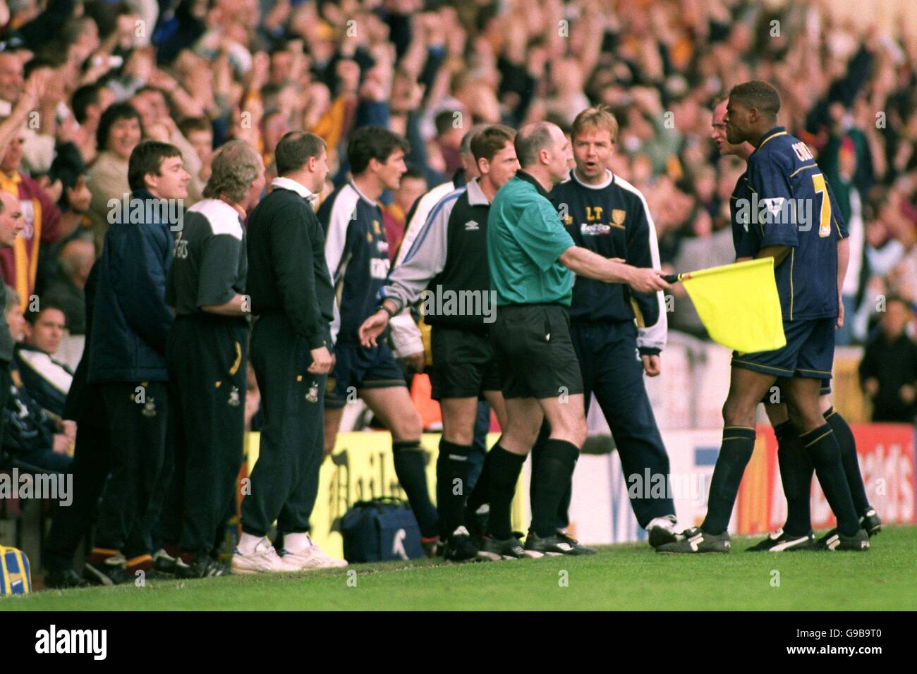 Wimbledon's John Hartson has words with the linesman before being shown ...