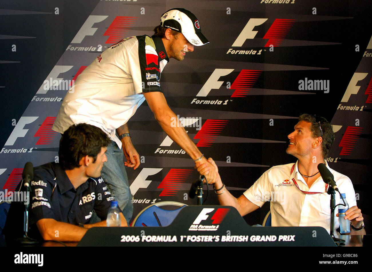 Honda's Jenson Button (centre) shakes hands with Red Bull Racing's ...