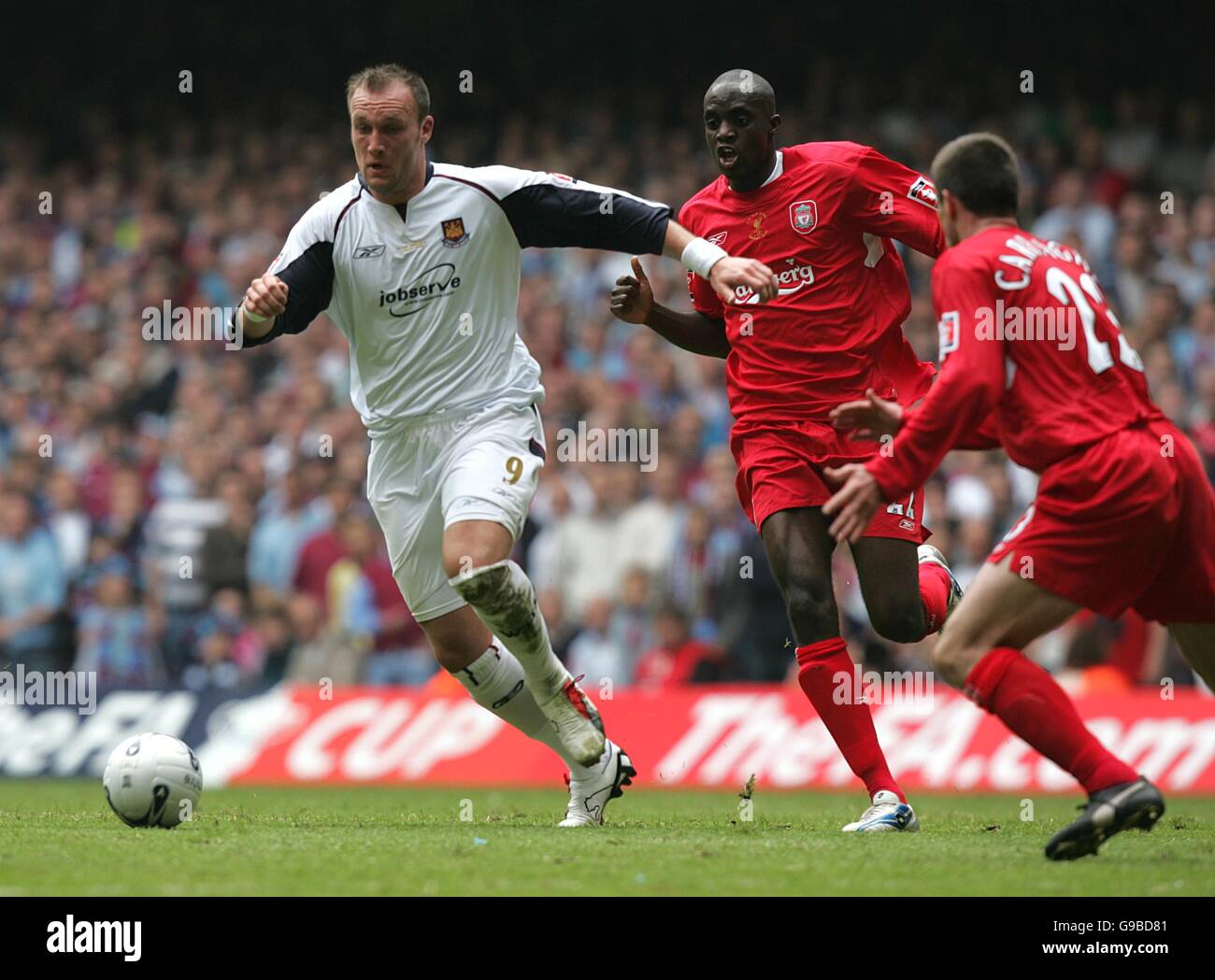West Ham United's Dean Ashton is challenged by Liverpool's Mohamed ...