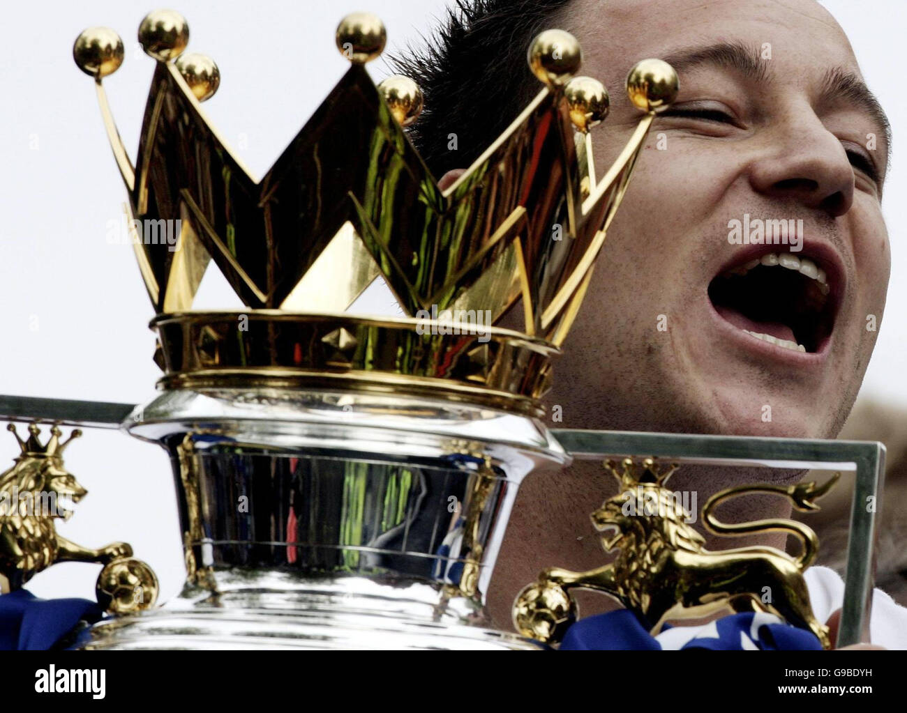 John Terry lifts up the Premiership trophy as Chelsea players salute ...