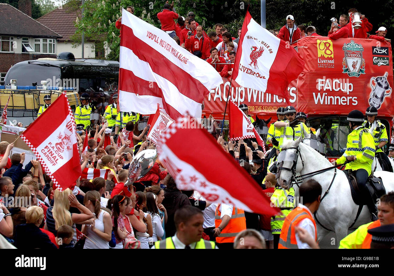Liverpool fans line the streets, as Liverpool players celebrate from ...