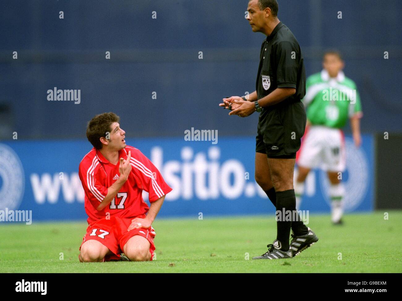 Referee Peter Prendergast (r) tells Canada's Paul Peschisolido (l) to ...