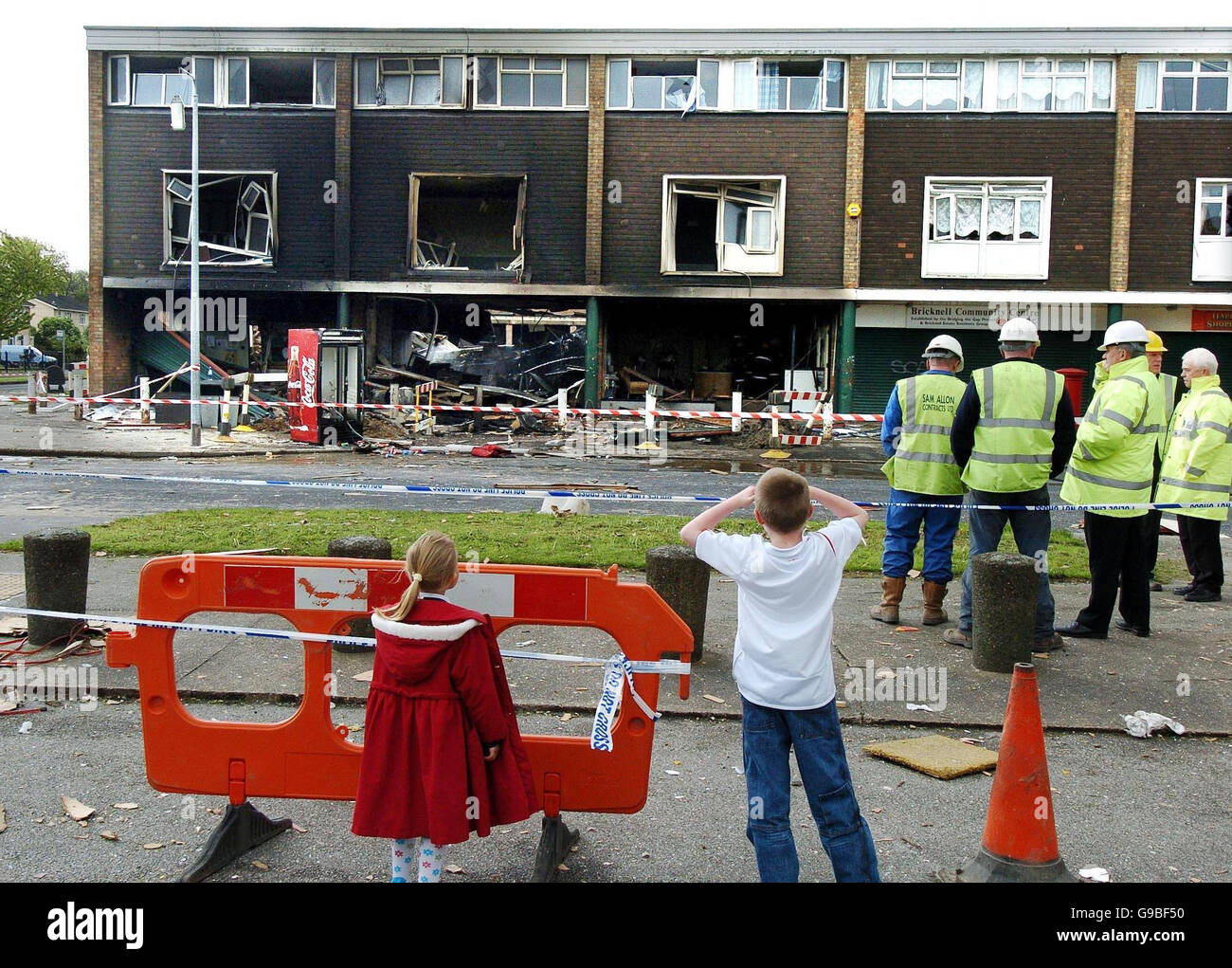 Children and workmen view the scene of an explosion in a kebab shop in ...