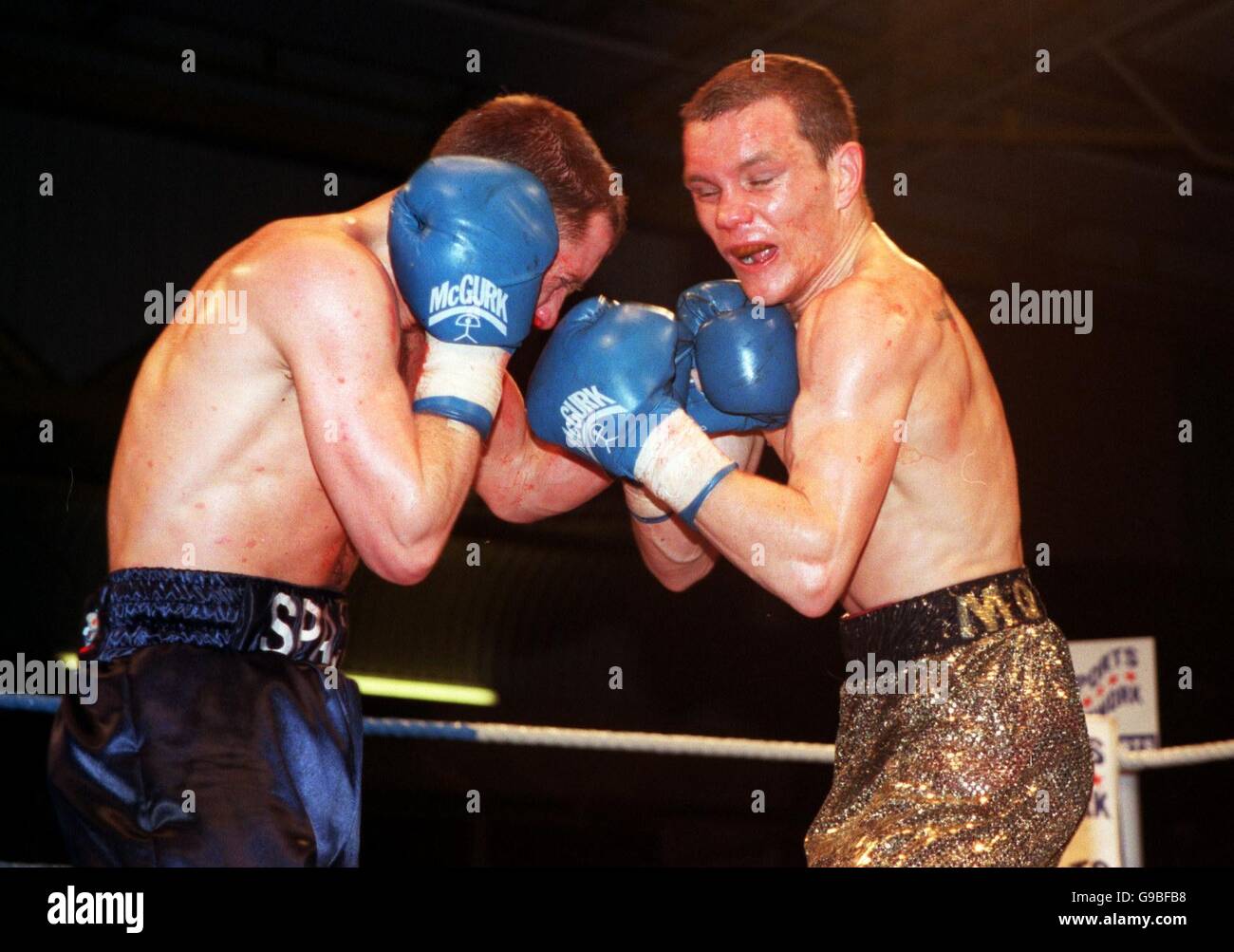 Craig Spacey (l) works on Alex Moon's chin in a close battle Stock ...