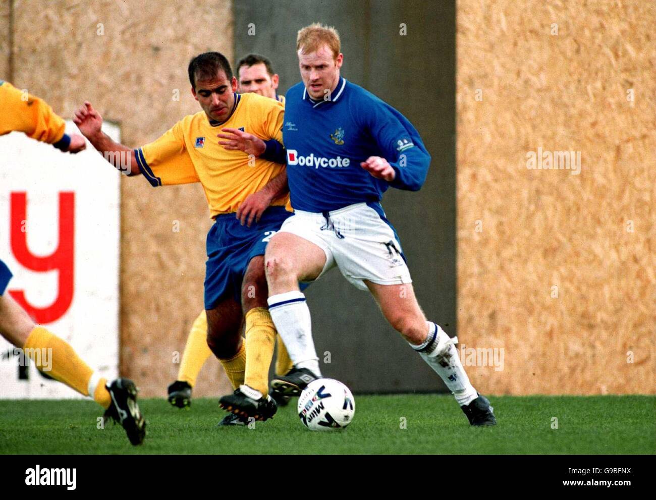 (L-R) Mansfield Town's Andy Roscoe tackles Macclesfield Town's Kieron ...