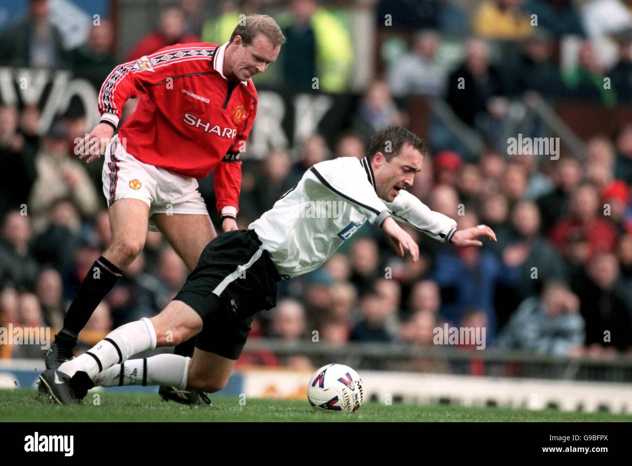 L r manchester uniteds henning berg tackles derby countys branko ...