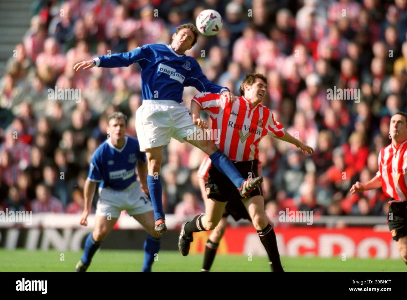 Everton's Joe-Max Moore (l) wins possession of the ball in the air from ...