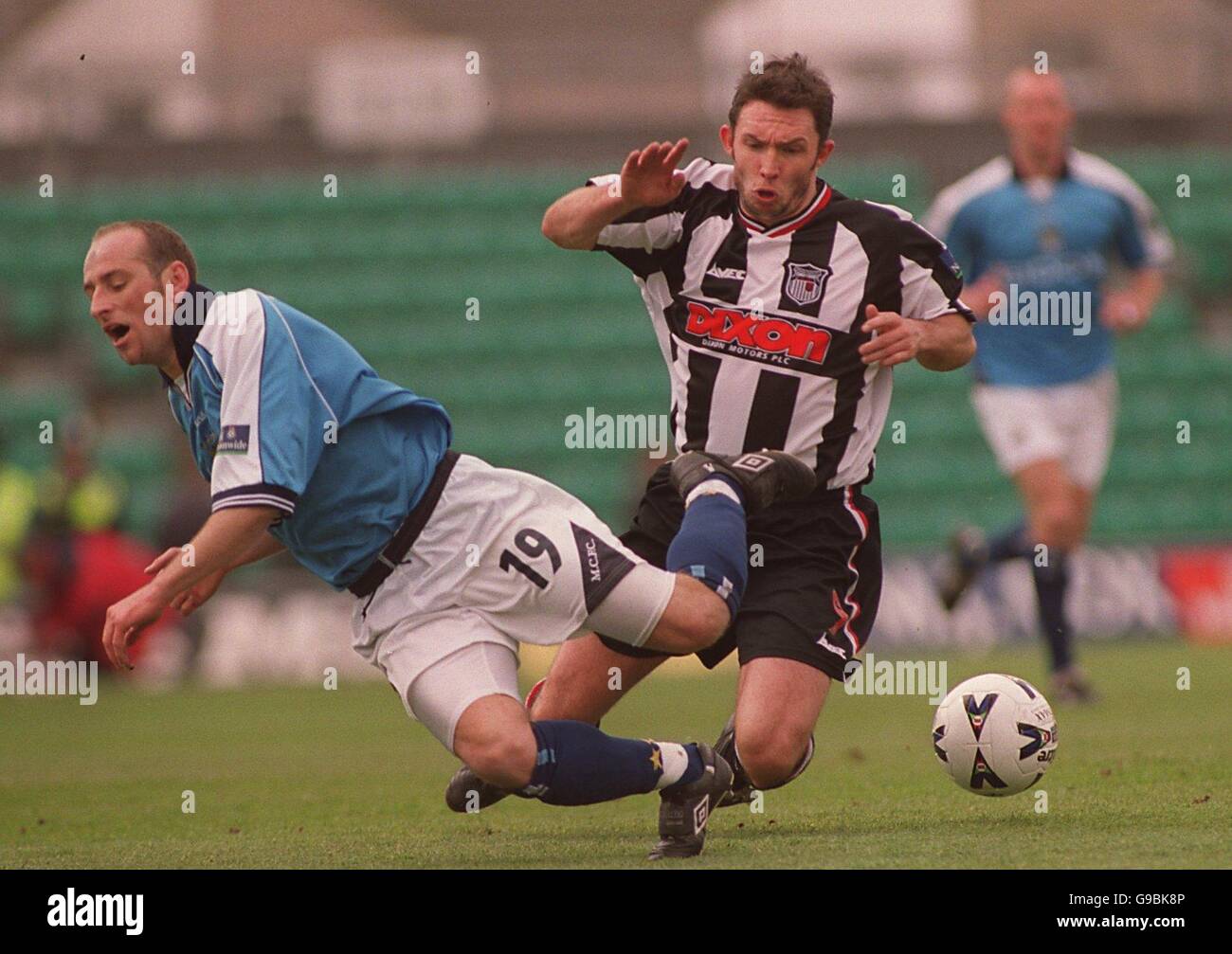 Manchester City's Danny Tiatto (l) is forced off the ball by Grimsby ...