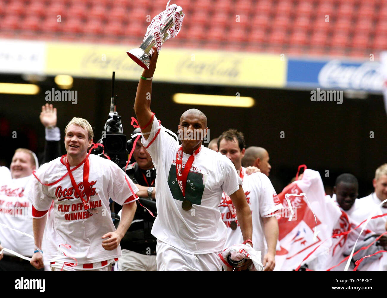 Cheltenham's Gavin Caines holds aloft the trophy after the Coca-Cola ...
