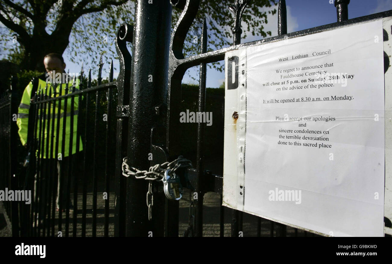 A man closes the cemetry gate after gravestones were knocked over and ...