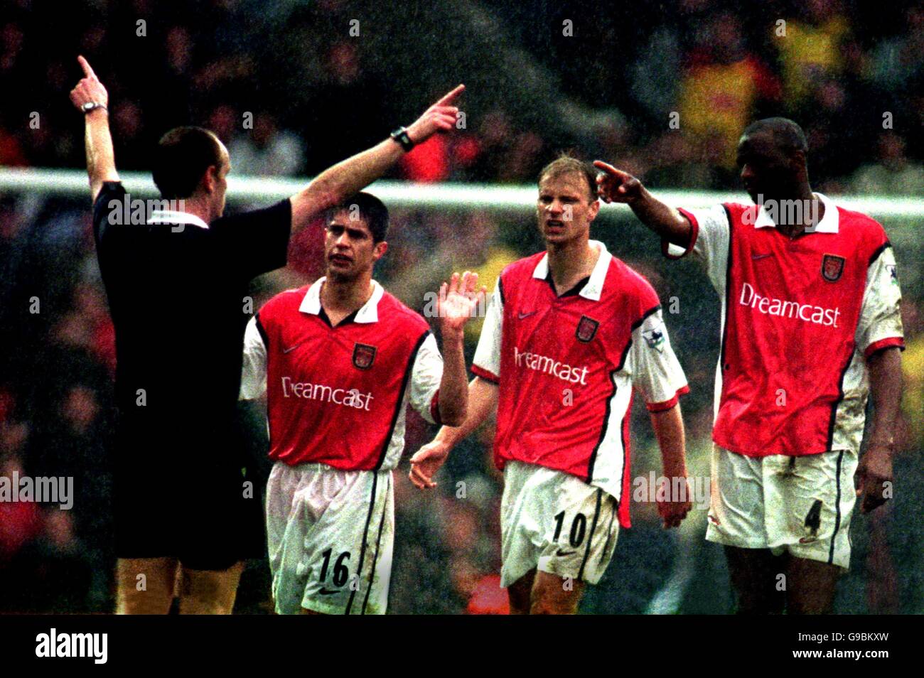 (L to R) Referee Rob Harris is harangued by Arsenal's Silvinho, Dennis ...