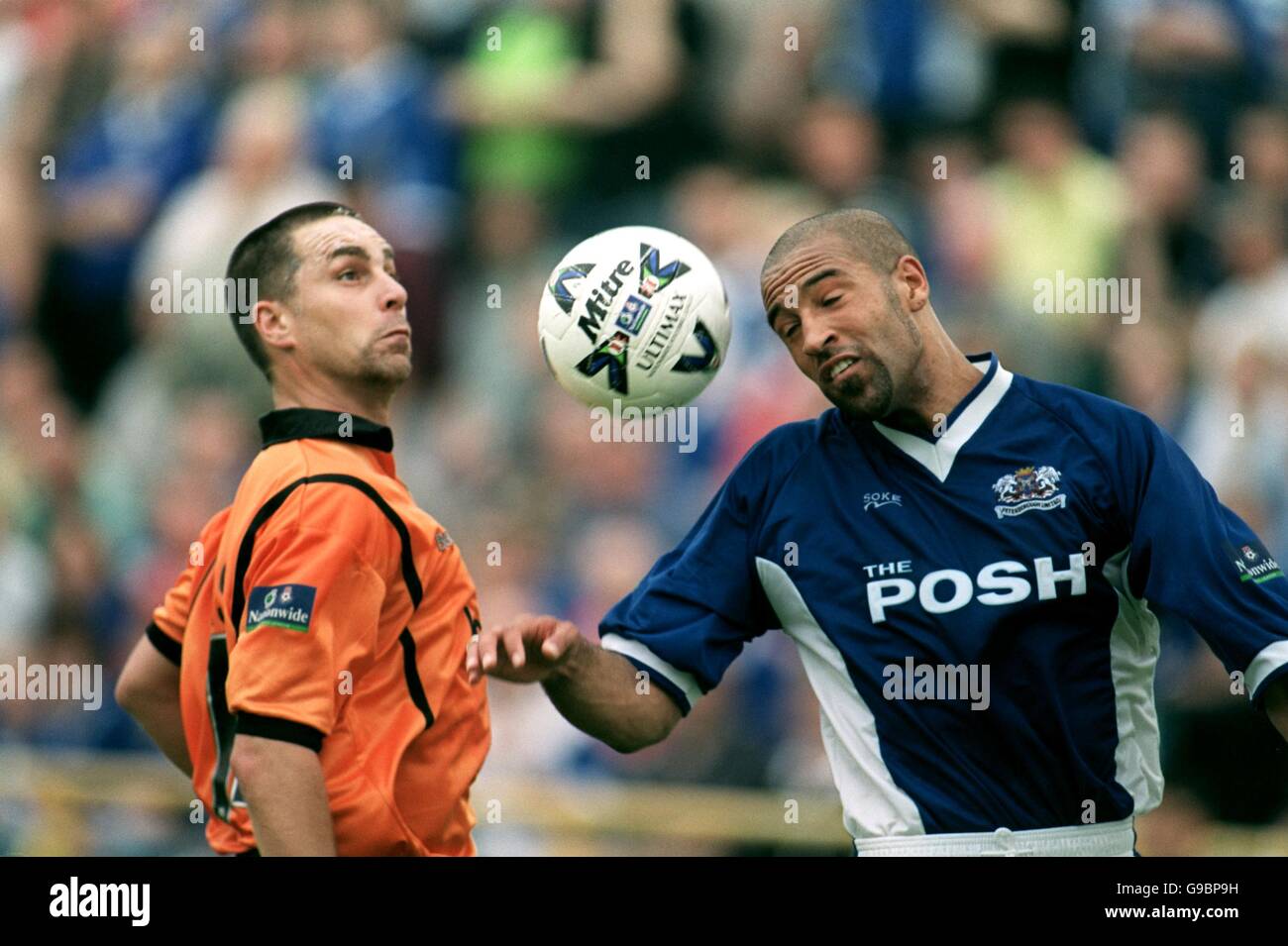 Barnet's Mark Arber and Peterborough United's Jason Lee both try to ...