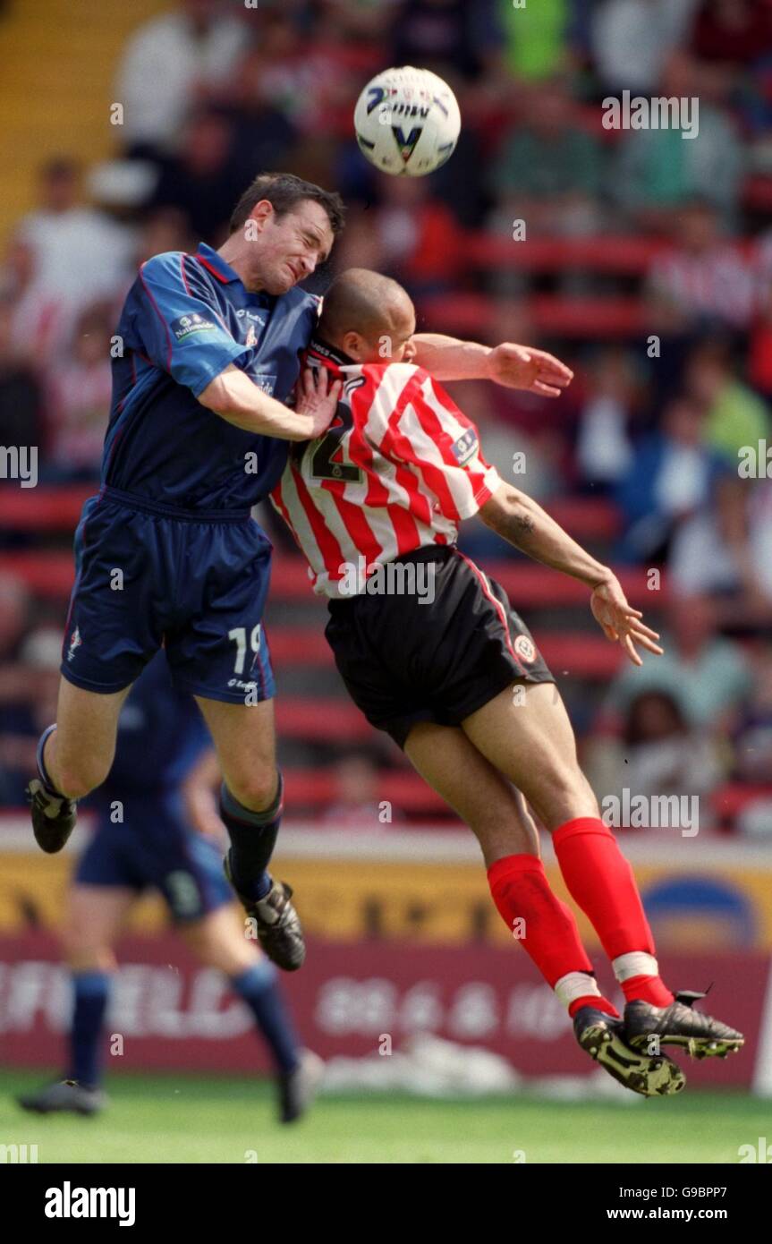 Swindon Town's Adam Willis and Sheffield United's Laurent D'Jaffo go up ...