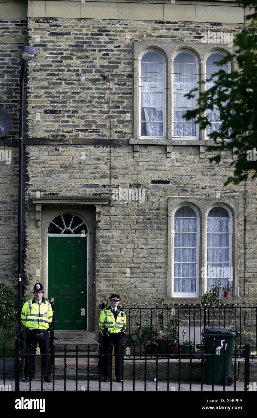 Police officers stand outside a house in Hanover square, Bradford ...