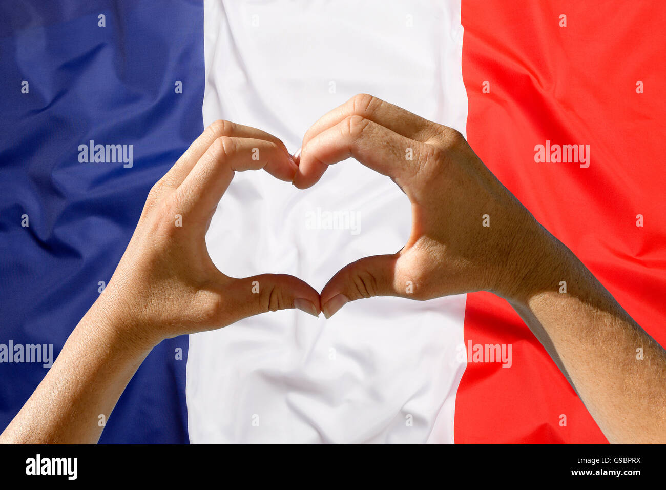 Female hands heart symbol with France flag in background Stock Photo ...