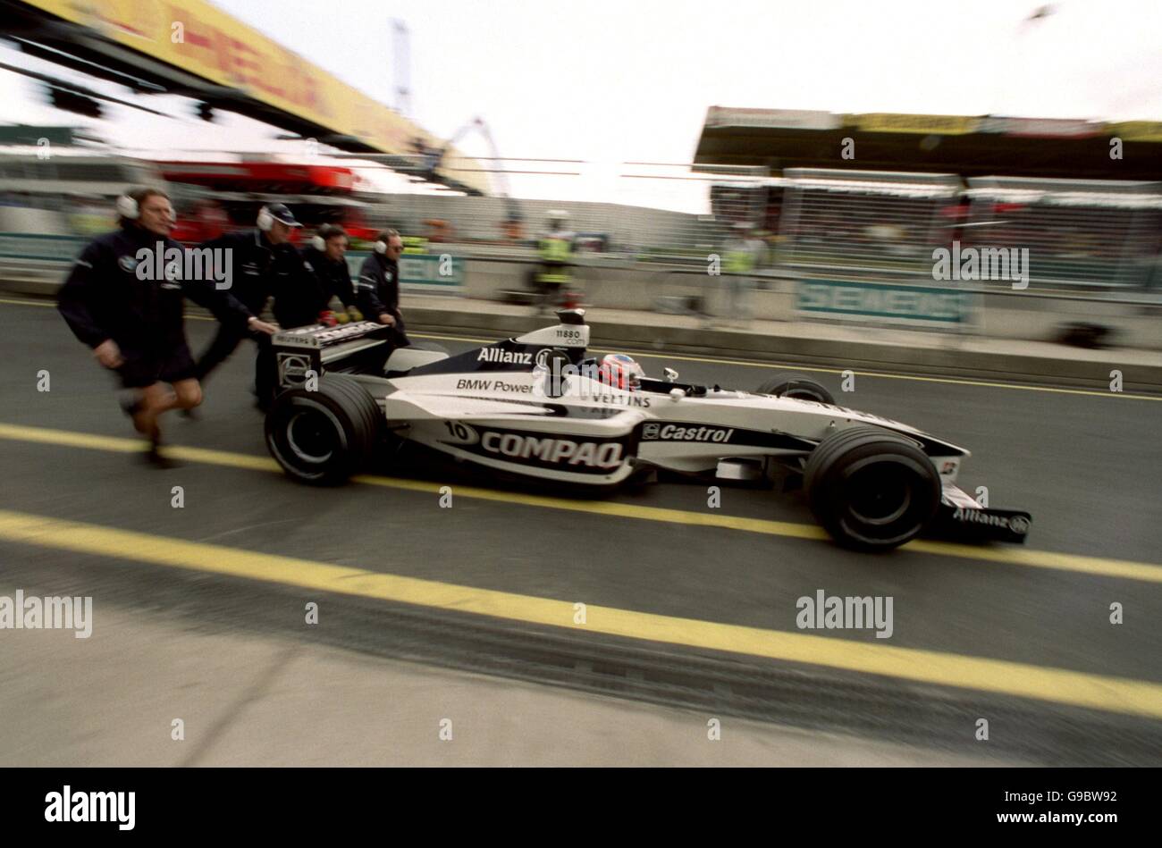 Williams' Jenson Button is pushed out of the pits by his crew to start ...