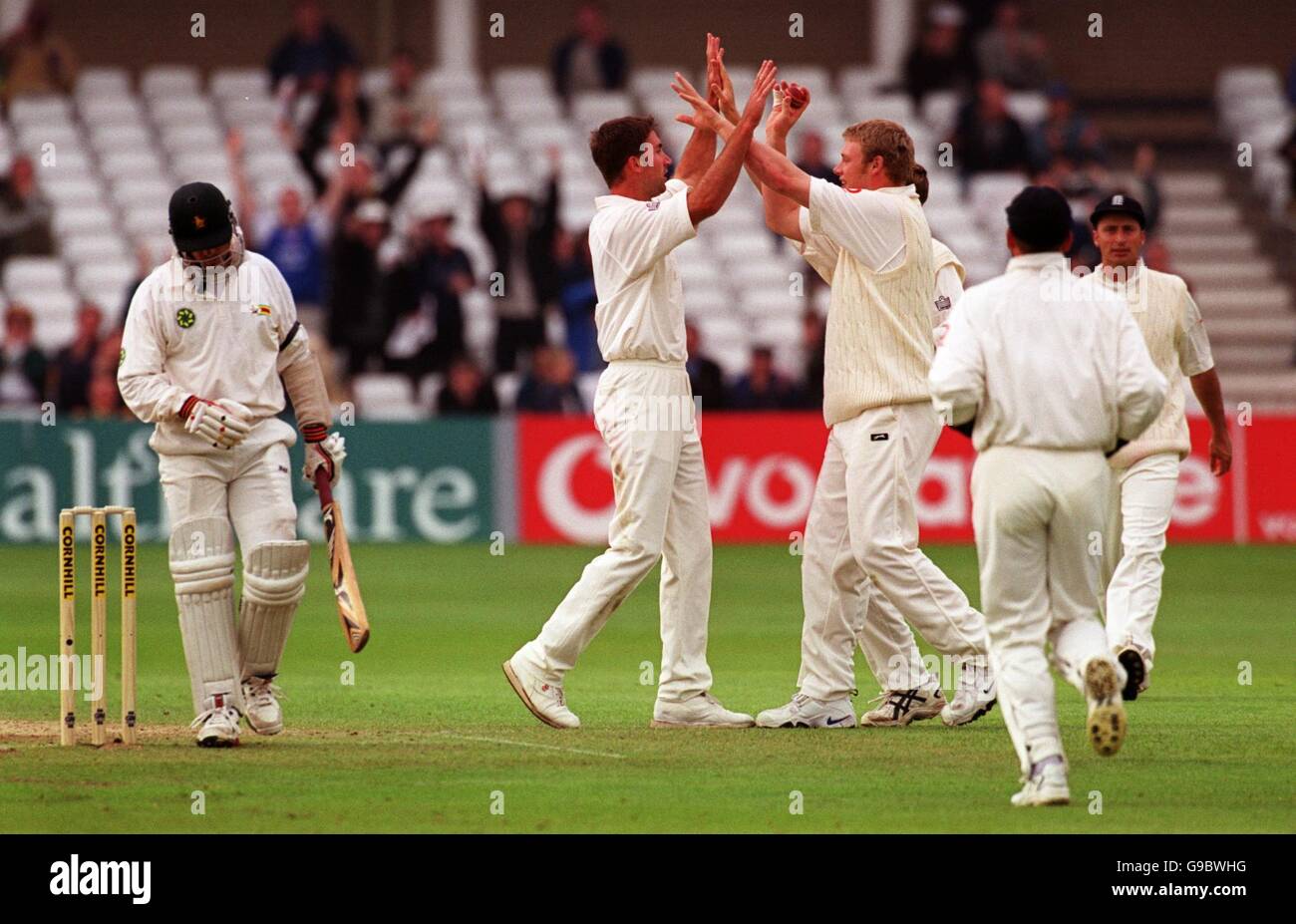 A dejected Guy Whittall (l) walks as England's Ed Giddins (second left ...