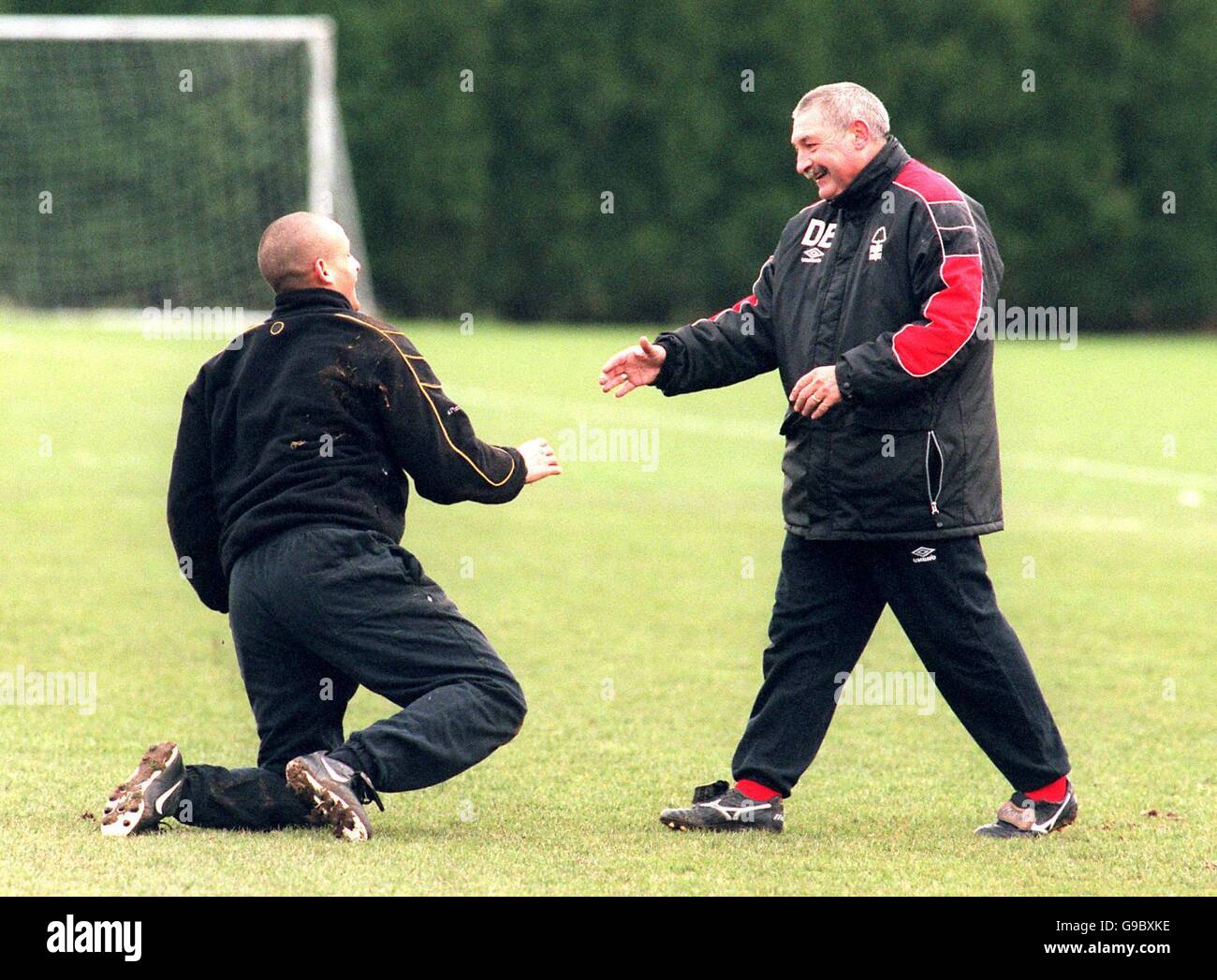 Nottingham Forest assistant manager Dennis Booth (r) helps up Nigel ...