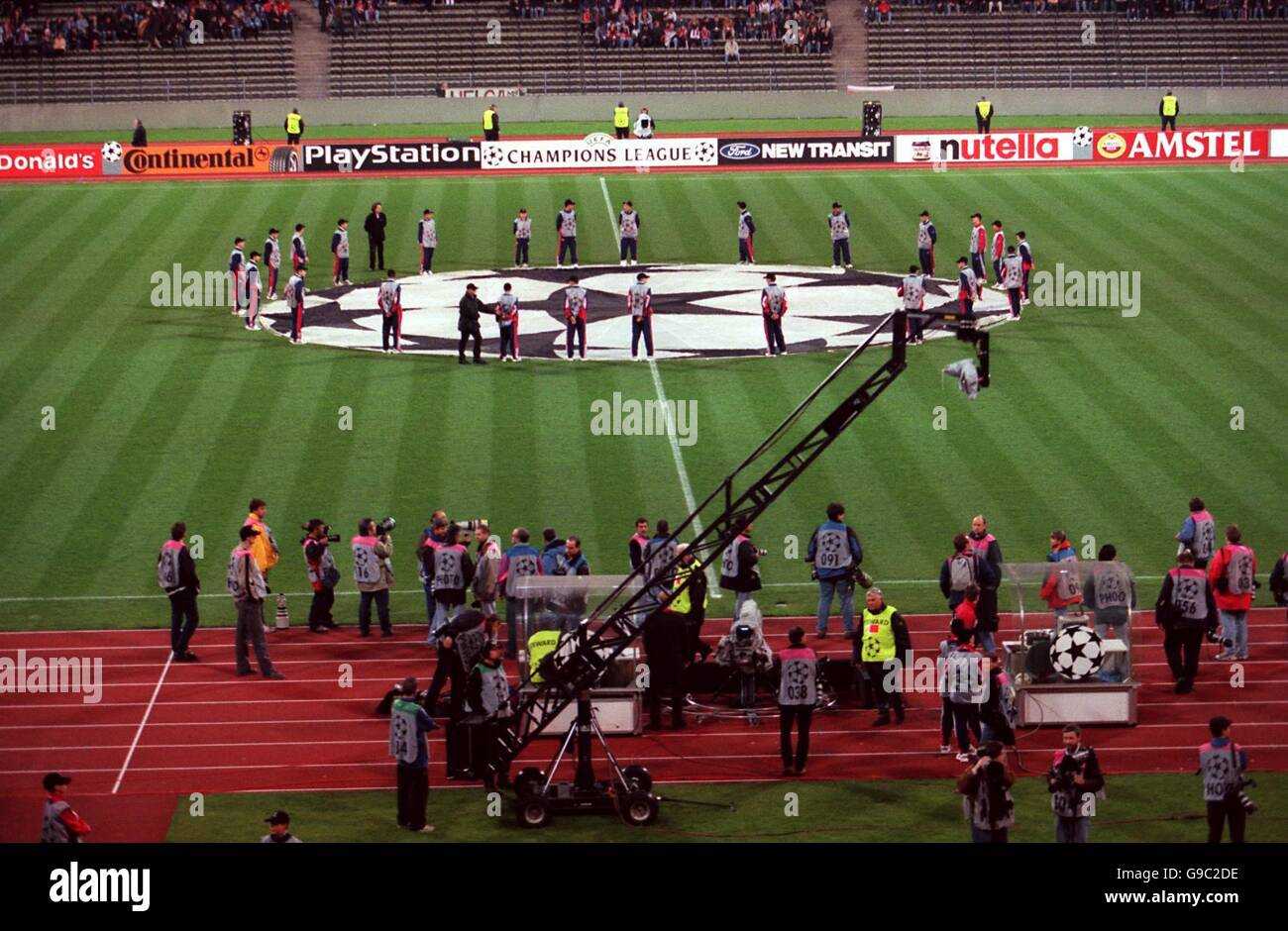 The television camera on the pitchside crane films the centre circle ...