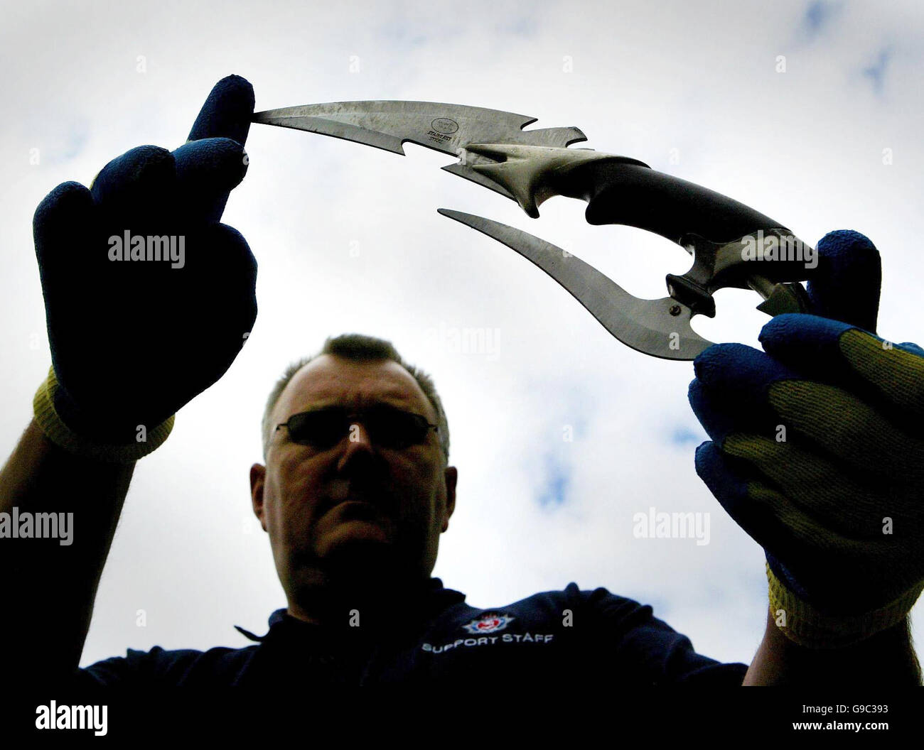 A member of Kent Police holds an example of one of the many knives ...