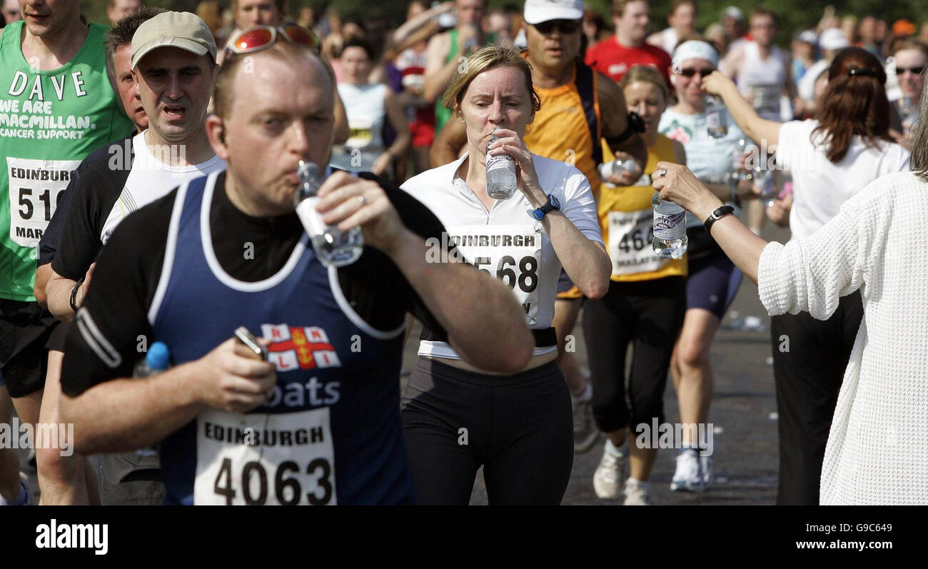 SCOTLAND Marathon. Runners drink water during the Edinburgh Marathon ...