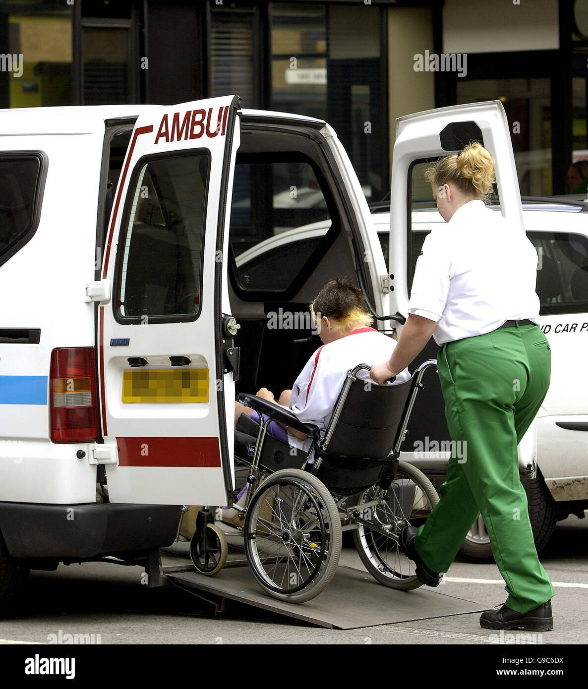 Generic stock picture of an ambulance worker helping a disabled person ...