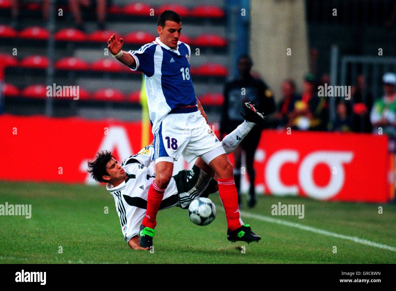 Slovenia's Zeljko Milinovic (l) falls over as he tackles Yugoslavia's ...