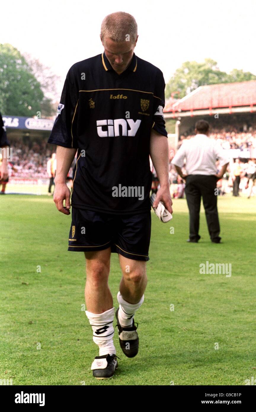Wimbledon's Ben Thatcher leaves the pitch with his head down after the ...