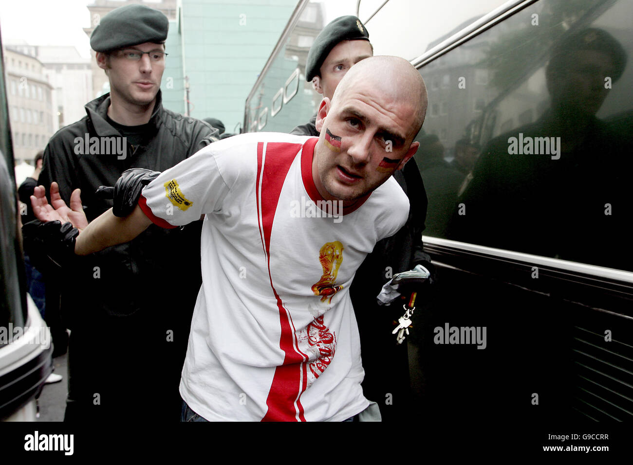 A German football fan is arrested by police in the centre of Dortmund ...