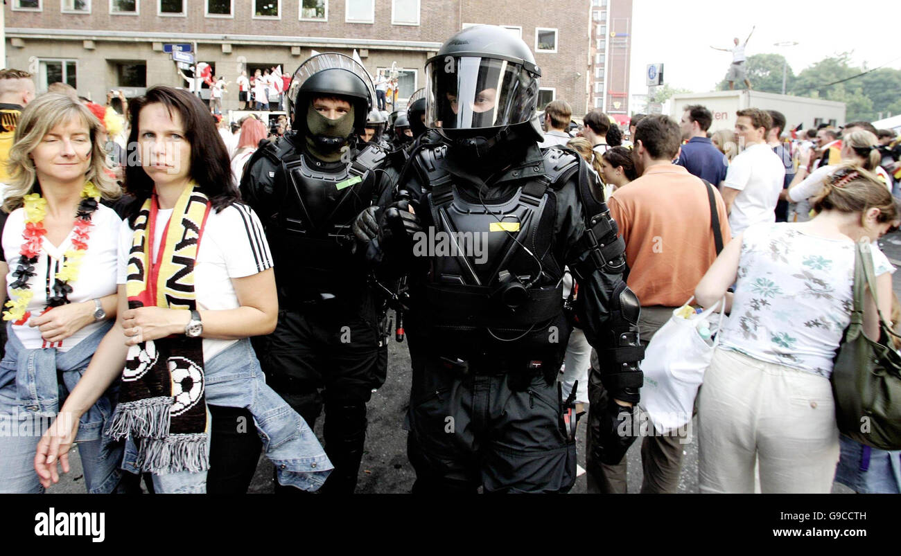 Riot police walk through a crowd in the centre of Dortmund as trouble ...