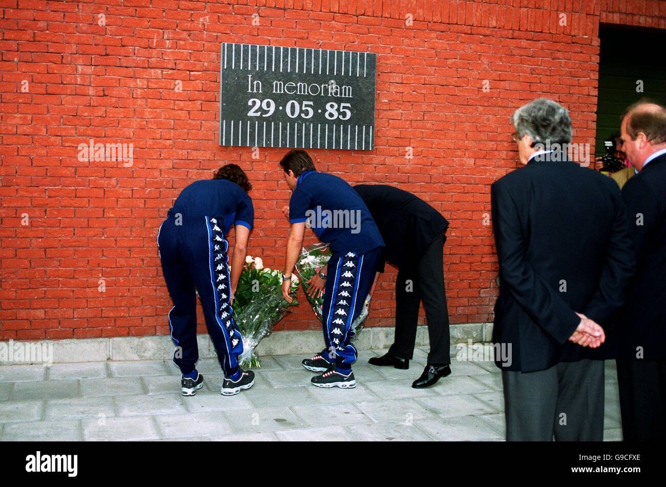 Two Italian players place bouquets of flowers beneath the Heysel ...