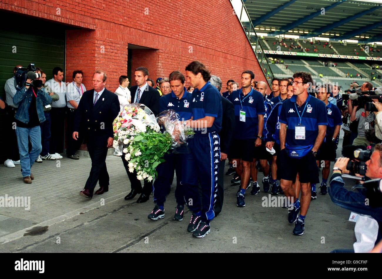 The Italy squad with two bouquets of flowers to be placed beneath the ...
