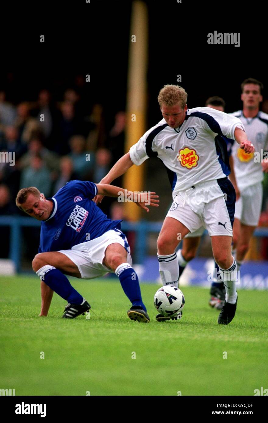 Chesterfield's Tom Curtis (l) slides into Sheffield Wednesday's Ritchie ...