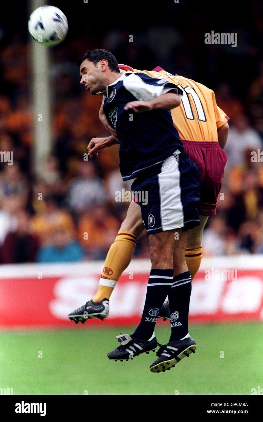Dundee's Patrizio Villio (l) is challenged by Motherwell's Stephen ...