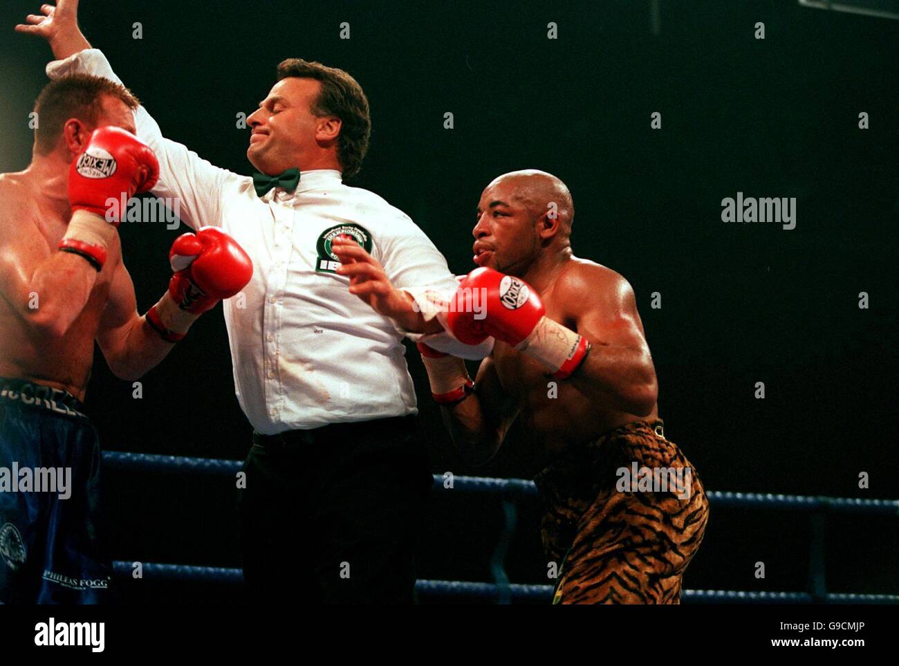 Referee James Santa (c) separates champion Adrian Stone (r) and ...