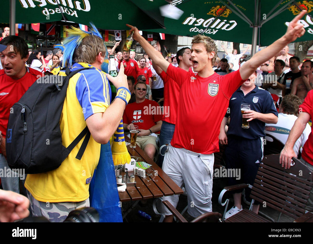 An England fan airs his views to a Swedish supporter in Cologne ...