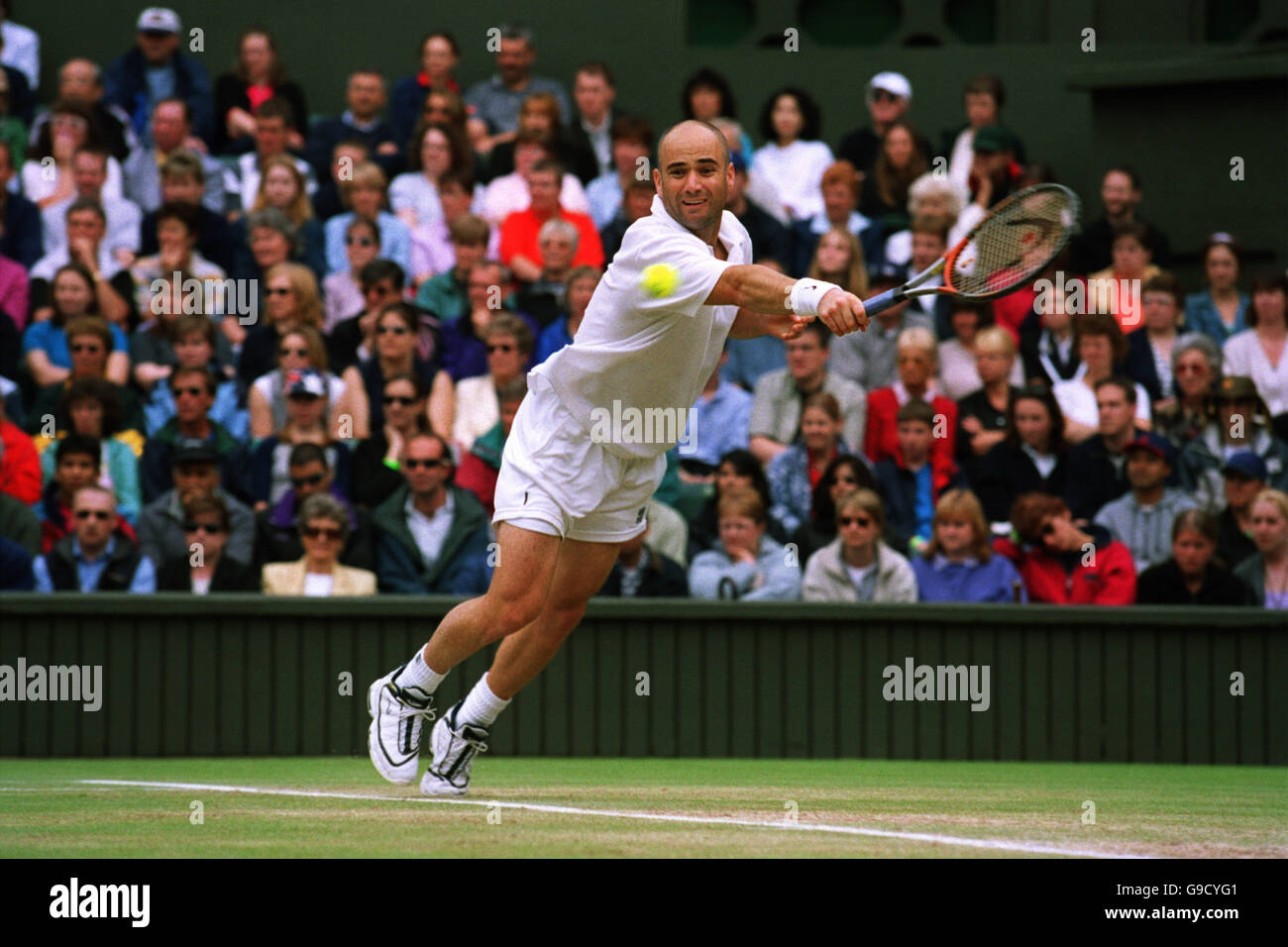 Andre Agassi stretches for the ball during his match with Australian ...