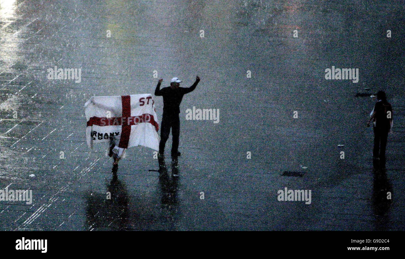 England fans dance in the rain in the centre of Schloss Platz ...