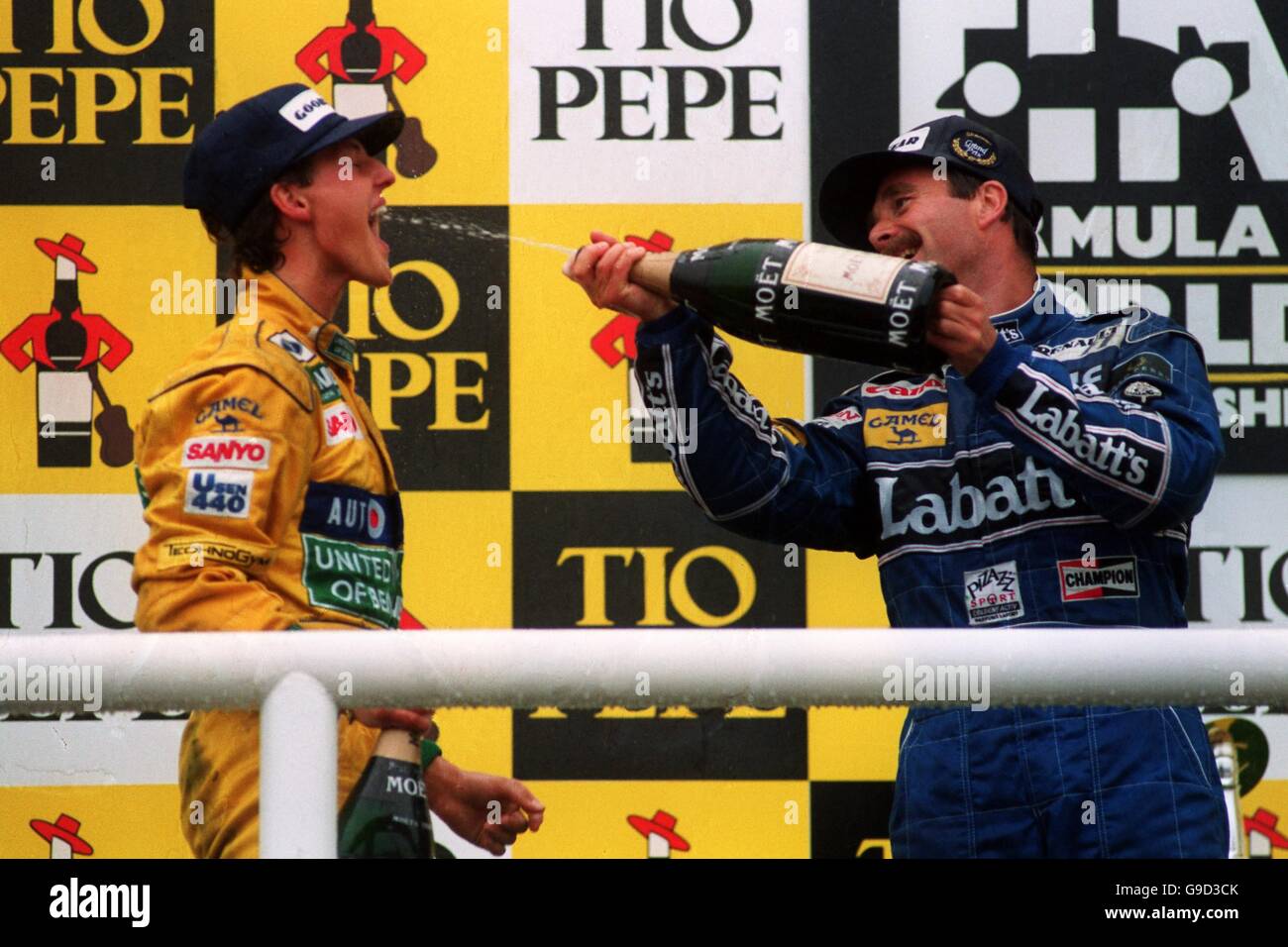Britain's Nigel Mansell (right) celebrates by giving Germany's Michael ...