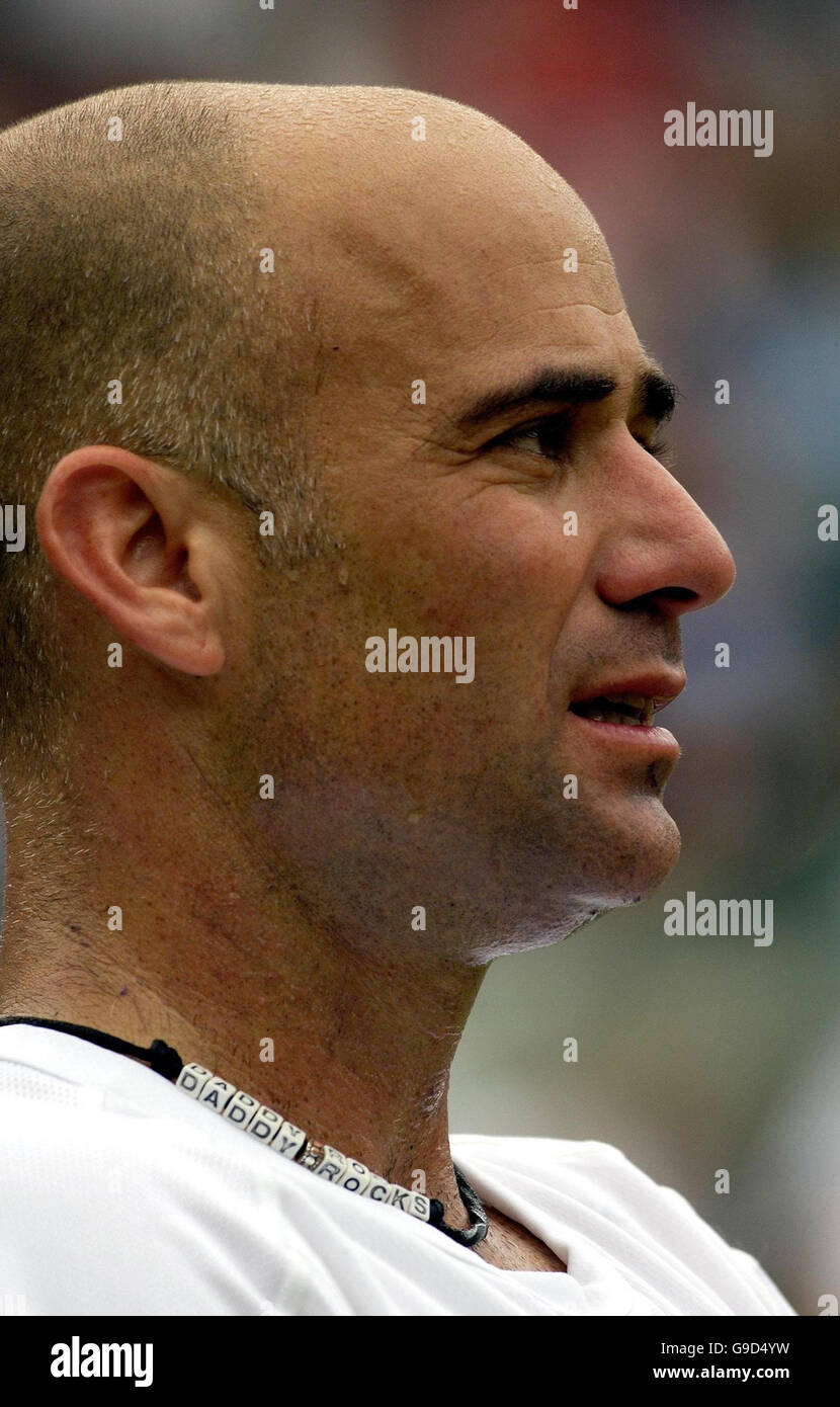 USA's Andre Agassi wearing a necklace reading "daddy rocks" against ...
