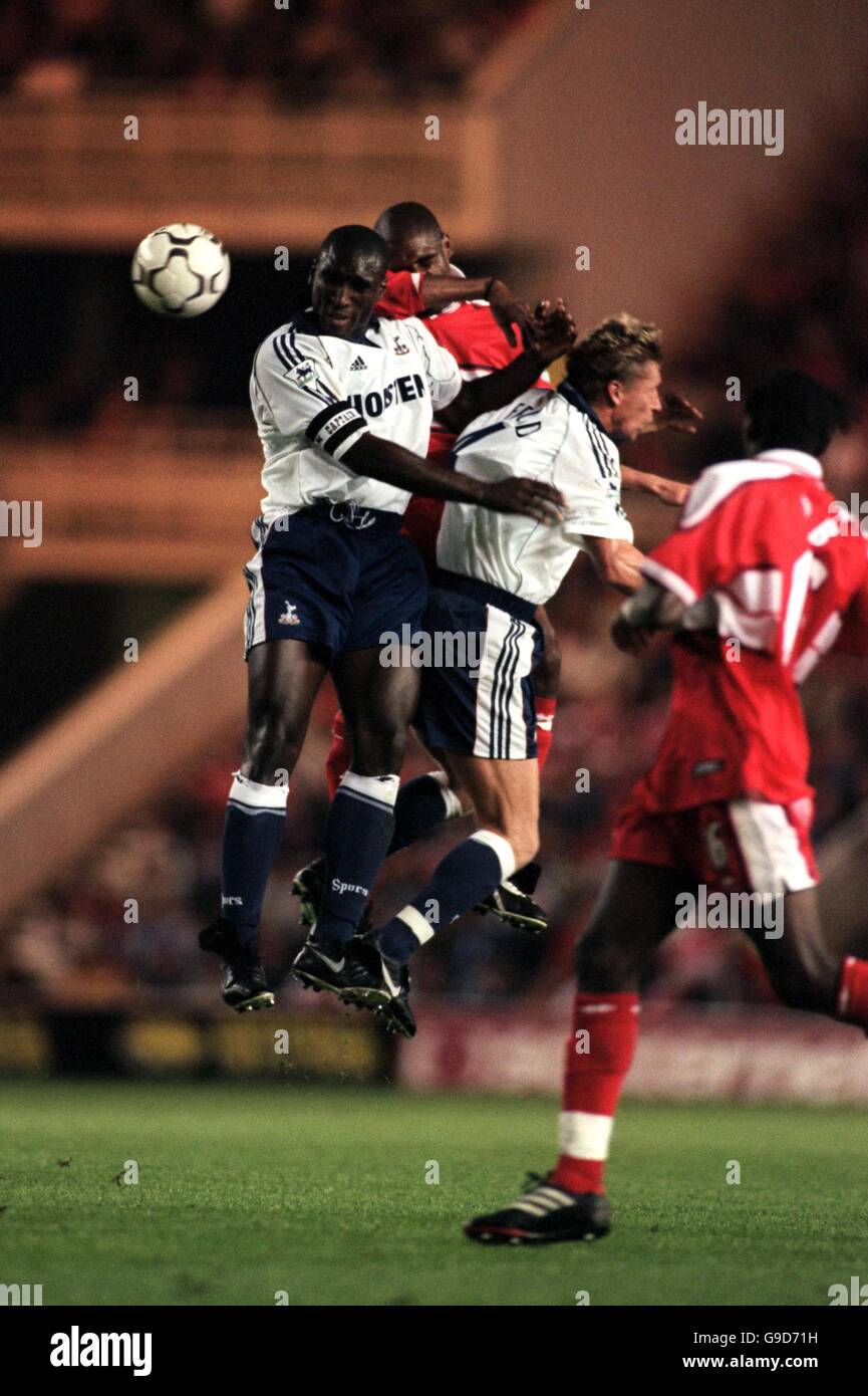 Middlesbrough's Brian Deane (c) is sandwiched in an aerial challenge ...