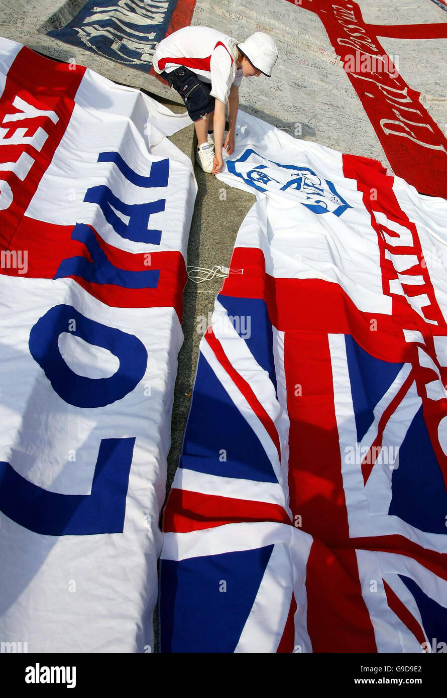 England fan Sam Horton, 9, from Barnsley, unfolds his flags in Cologne ...